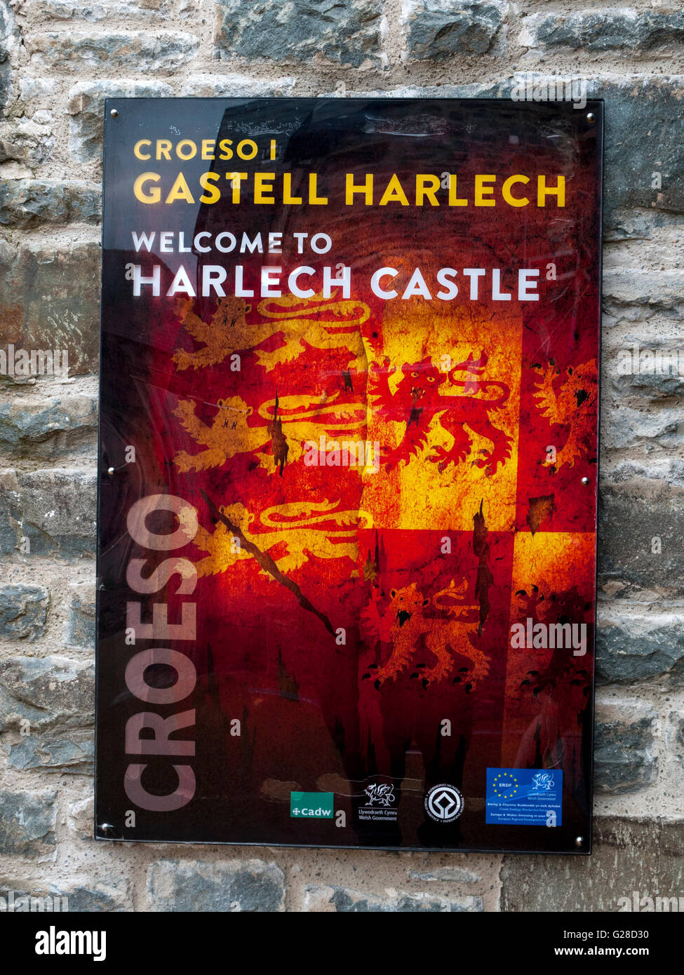 Welcome to Harlech Castle sign on outside wall Stock Photo - Alamy