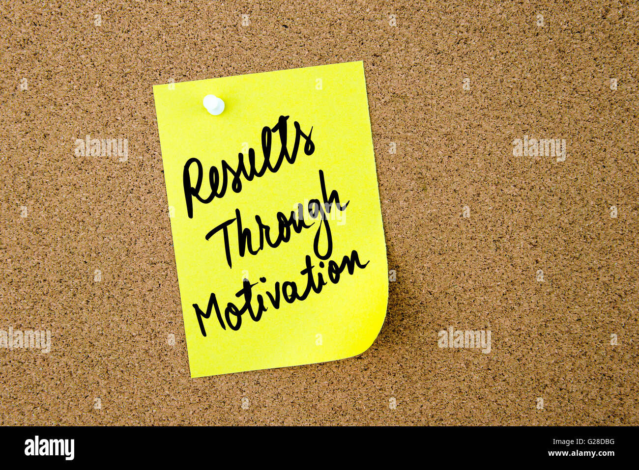 Results Through Motivation written on yellow paper note pinned on cork ...
