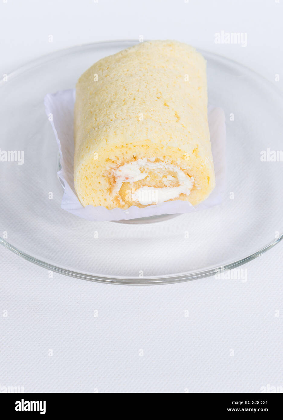 Soft roll cake with the glass plate on the white background Stock Photo ...