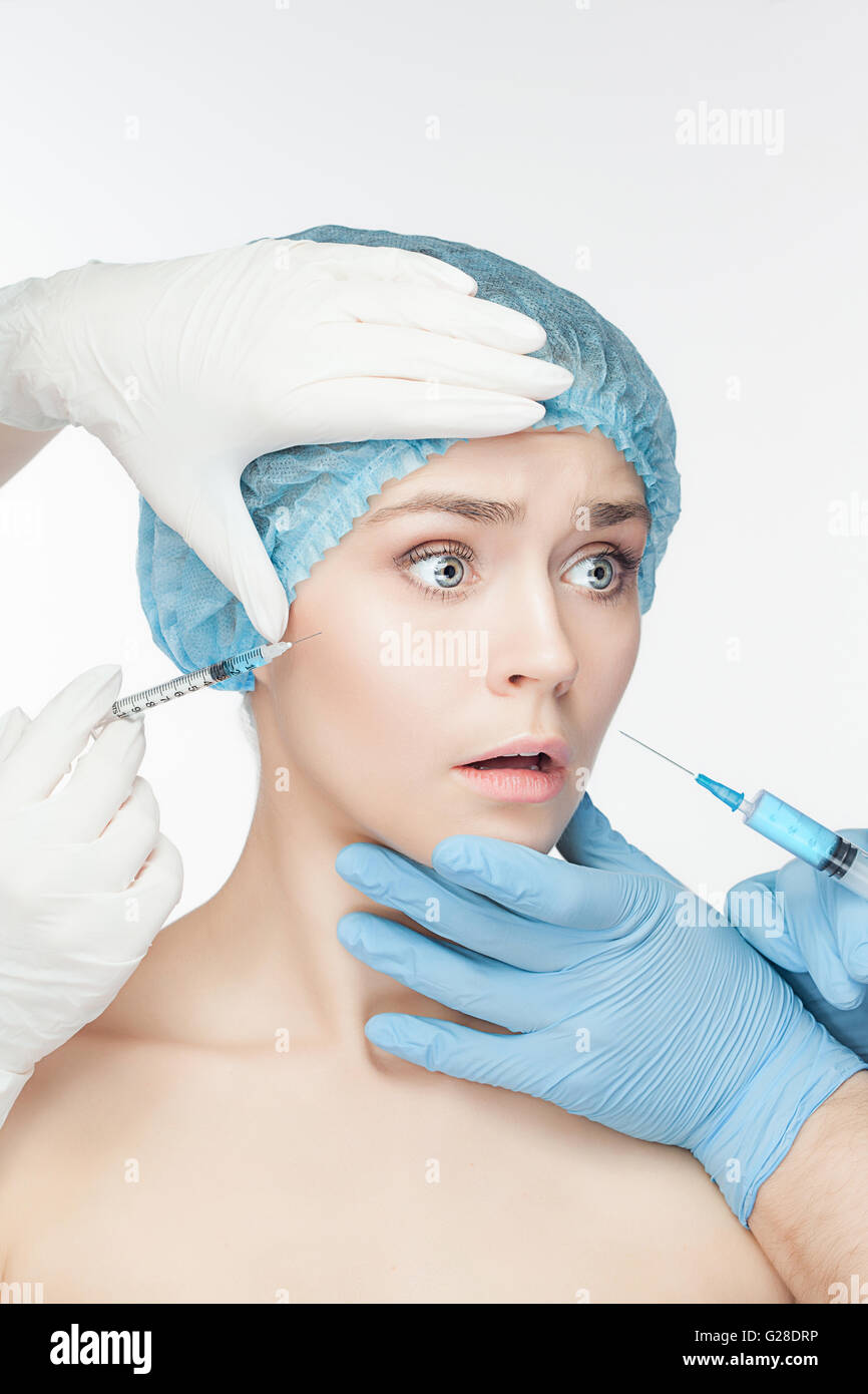 Attractive woman at plastic surgery with syringe in her face Stock ...