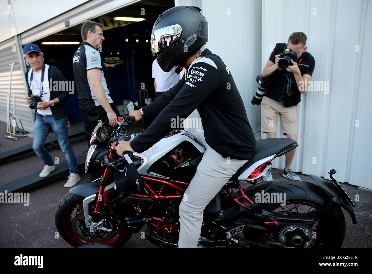 Mercedes driver Lewis Hamilton leaves the pit lane on his bike at the ...