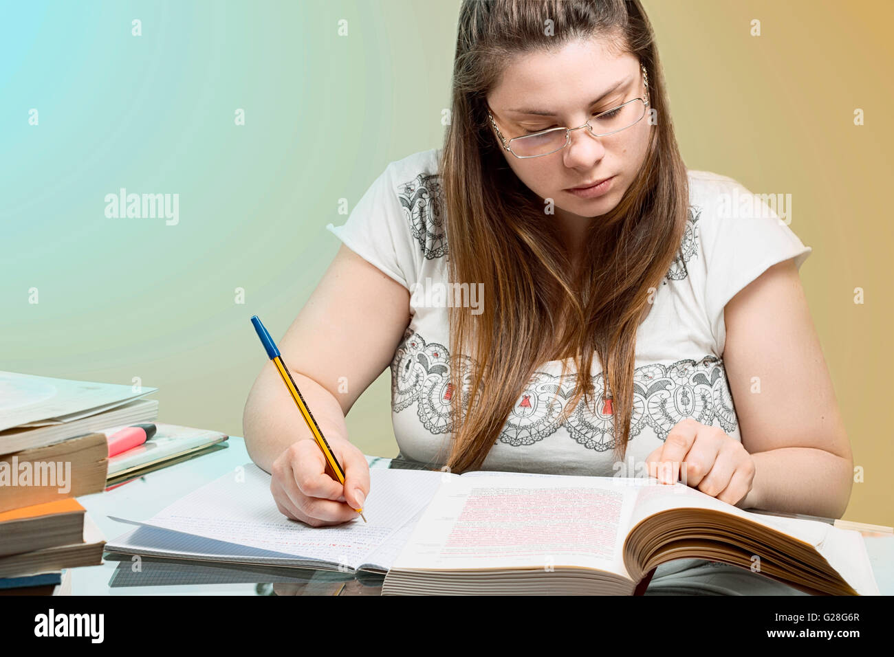 girl studying with pen in hand Stock Photo - Alamy