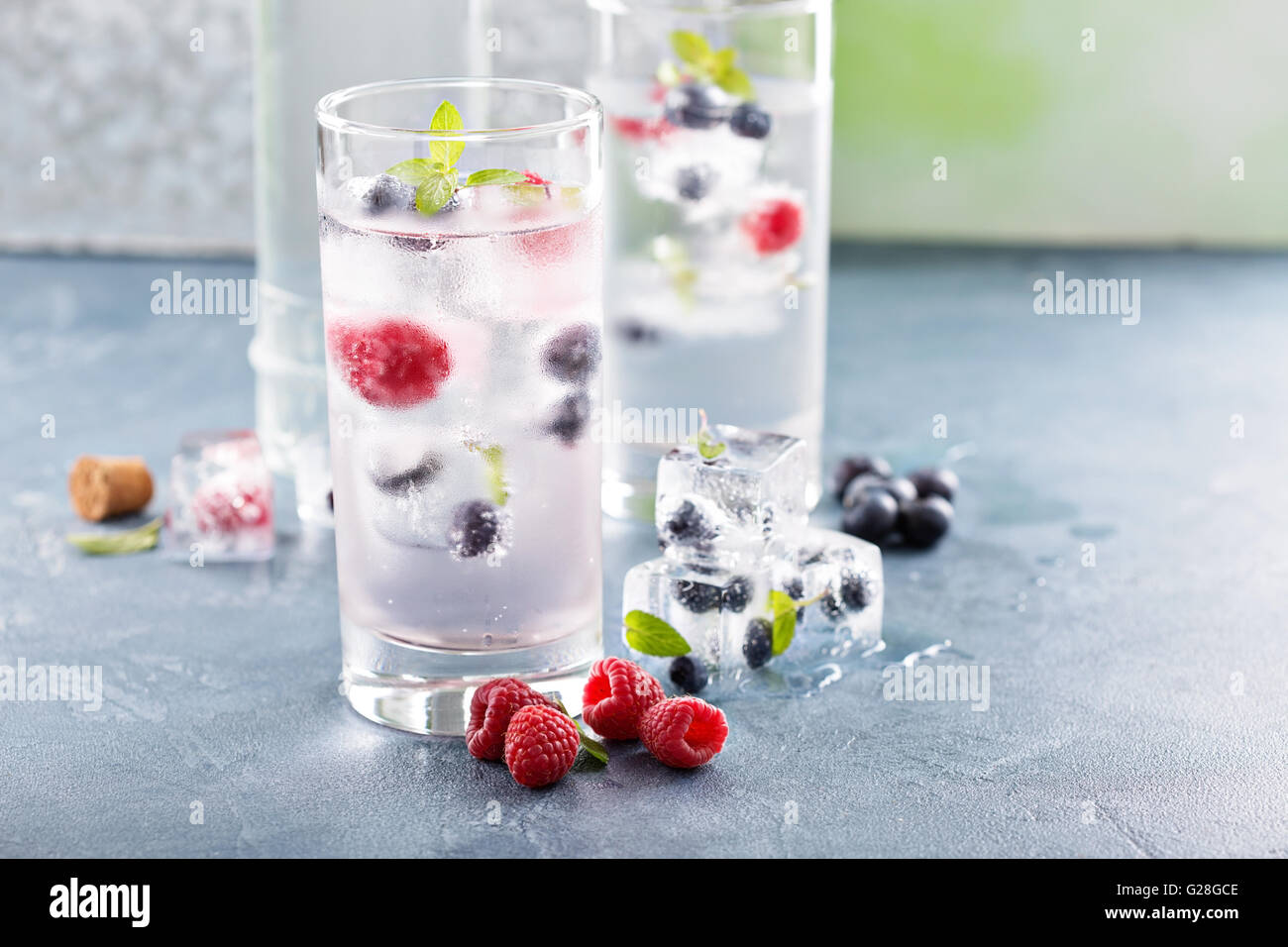Sparkling water with berry and herb ice Stock Photo - Alamy