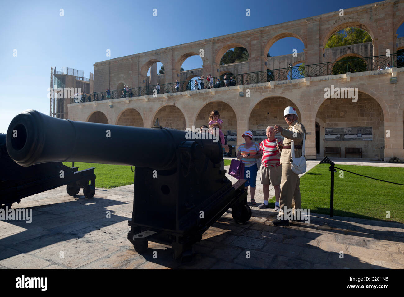 A site guide in British military fatigues shows tourists an Iron SBBL ...