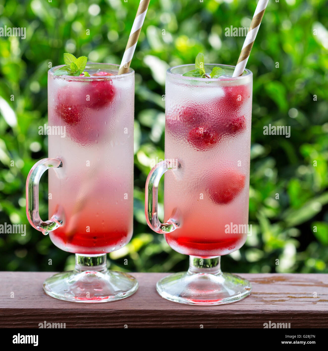 Pink raspberry lemonade in tall glasses Stock Photo - Alamy