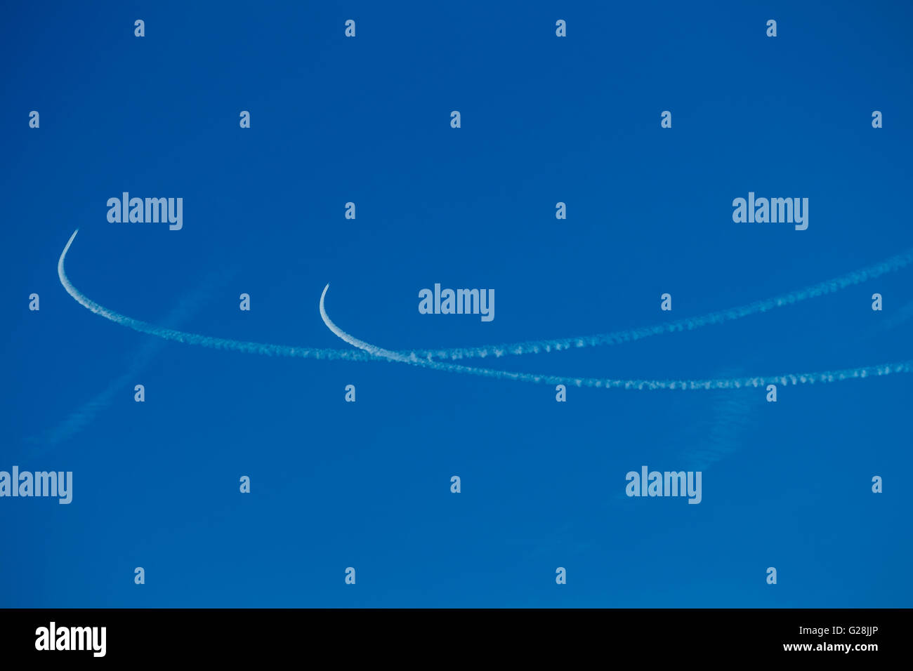 Aerial view, contrails in the blue sky with exercises of fighter jets ...