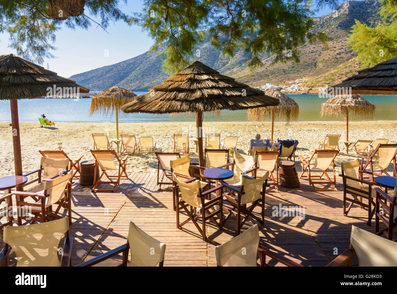 Cafe views of sun shades and deck chairs on Kamares Beach, Kamares Town ...