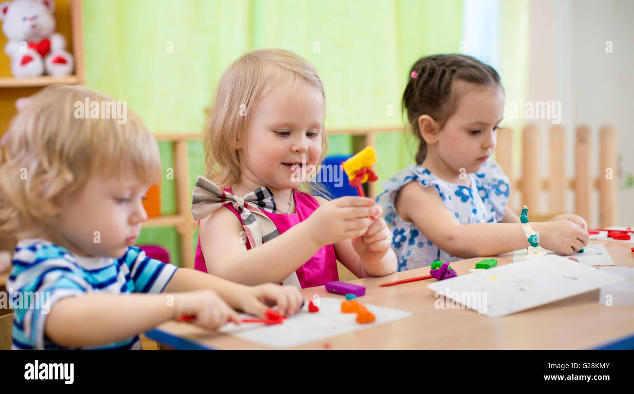 Kids making arts and crafts. Children in kindergarten Stock Photo - Alamy