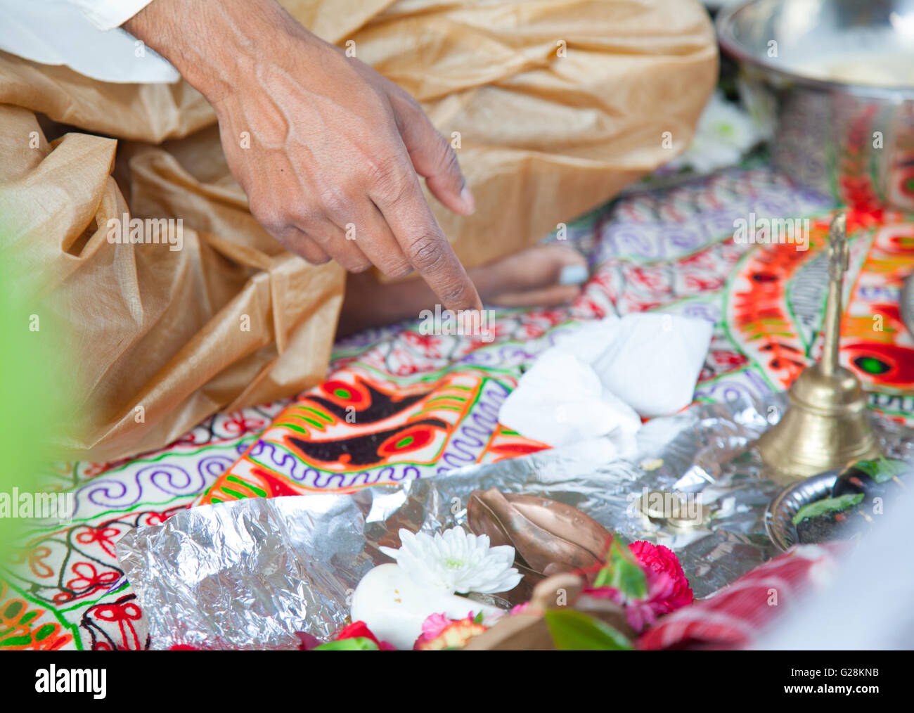 Close up detail as a Hindu priest conducts a Anaprasan religious ...