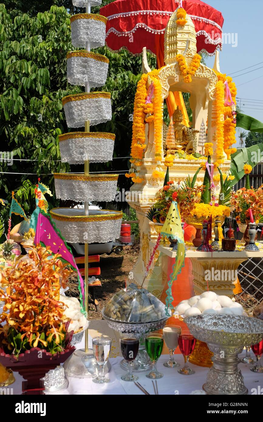 Spirit house in Chiang Mai, Thailand, surrounded by offerings at spirit ...