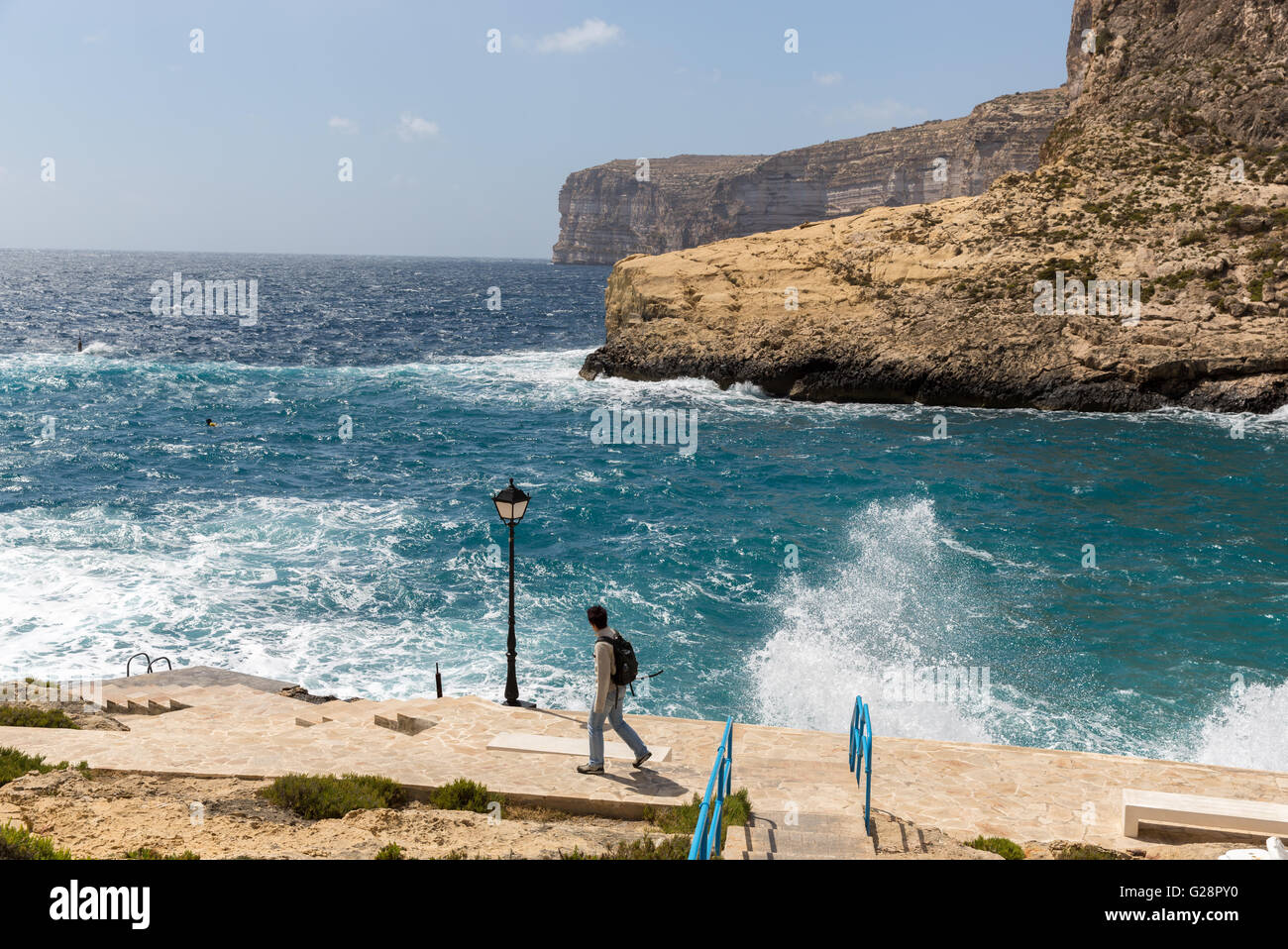 A woman on a coastal walk at Xlendi on the Maltese Island of Gozo Stock ...