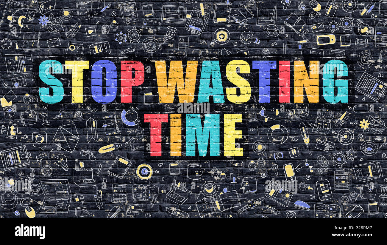 Stop Wasting Time on Dark Brick Wall Stock Photo - Alamy