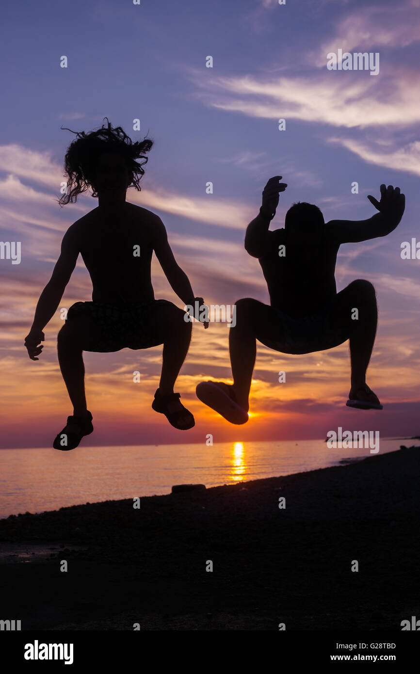 Two man jumping Stock Photo - Alamy