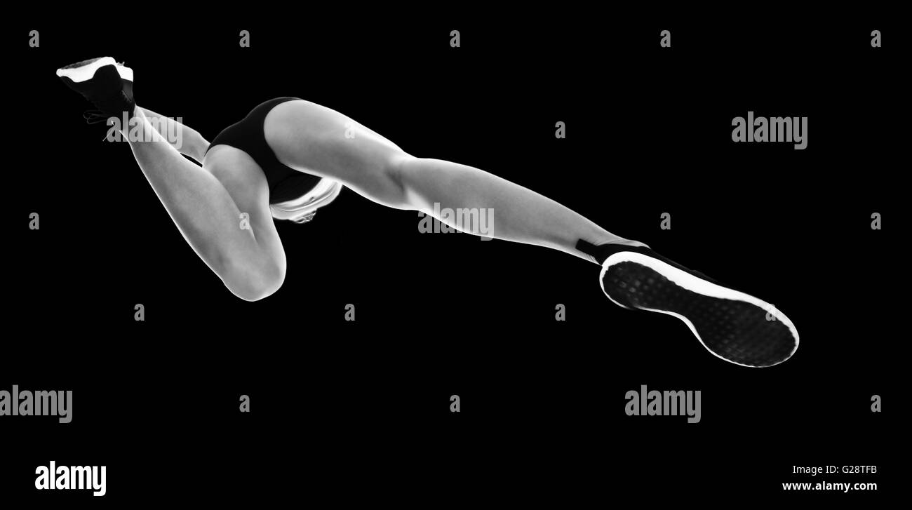 Low angle female athlete jumping Stock Photo - Alamy
