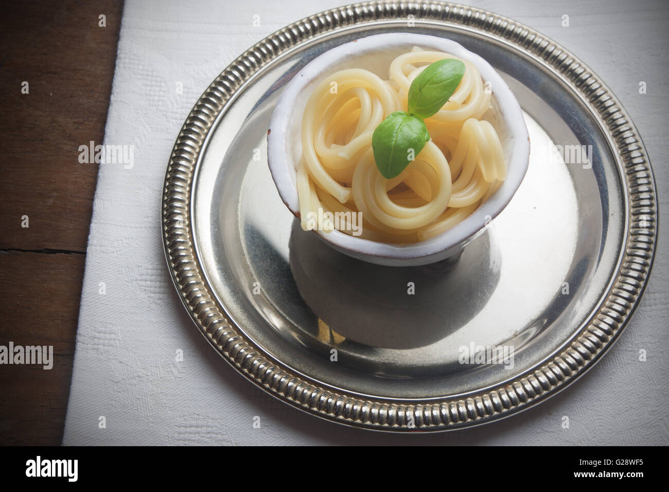 A very small portion of pasta with basil Stock Photo - Alamy