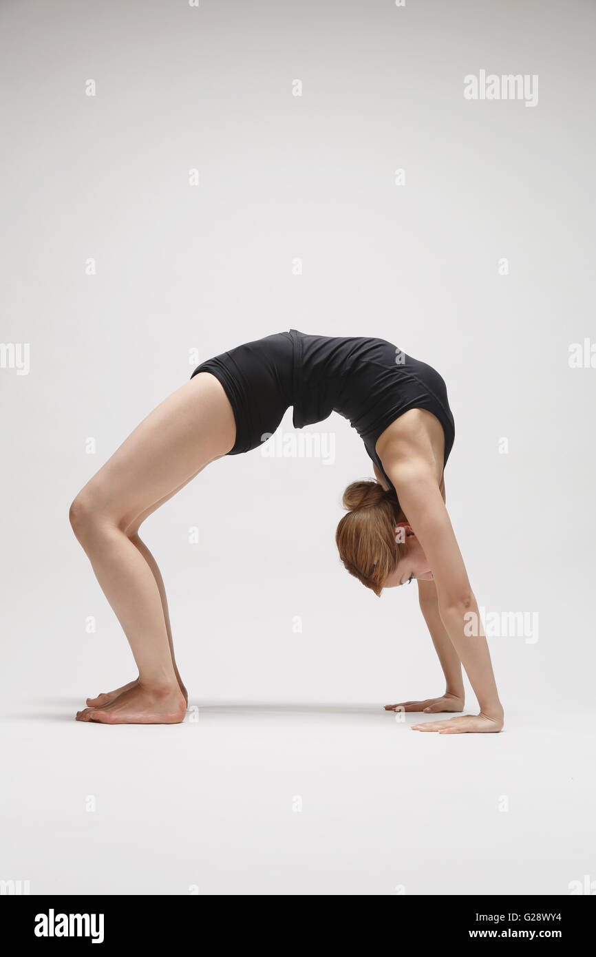 Attractive young Japanese woman wearing black pants and tank top ...