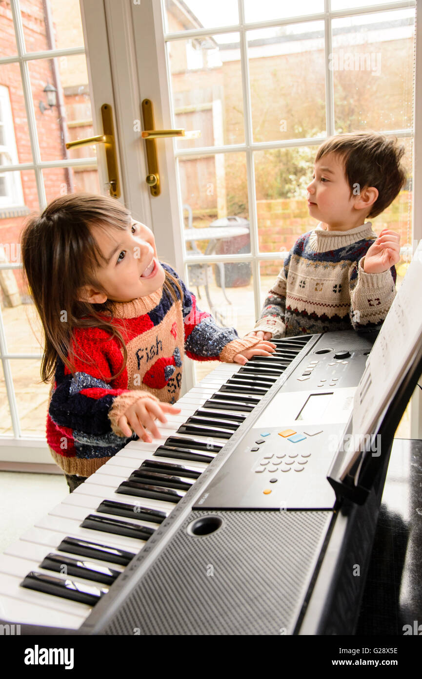 Kids playing piano Stock Photo - Alamy