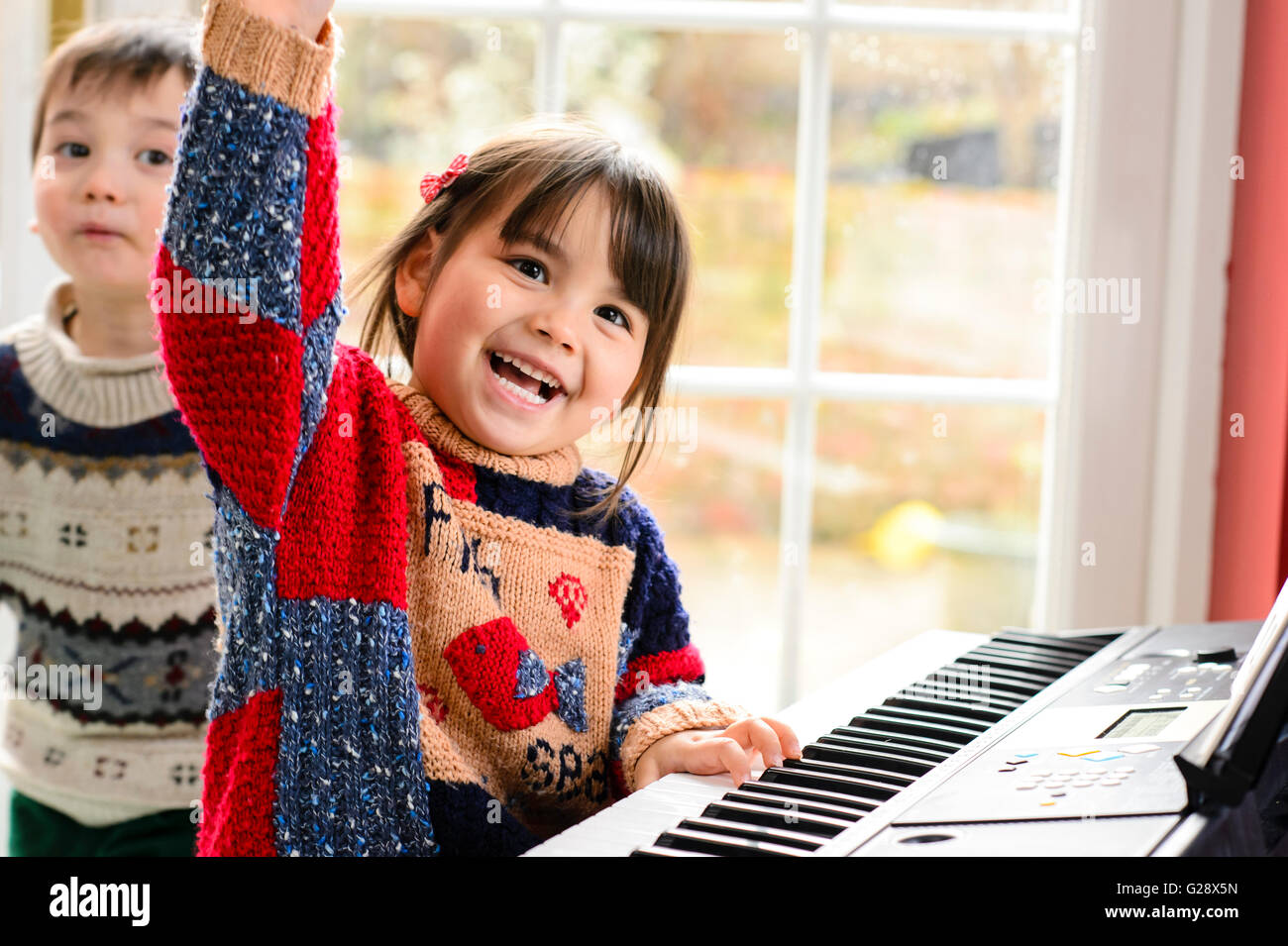 Kids playing piano Stock Photo - Alamy