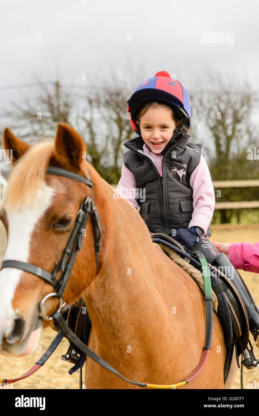 Kid riding on a horse Stock Photo - Alamy