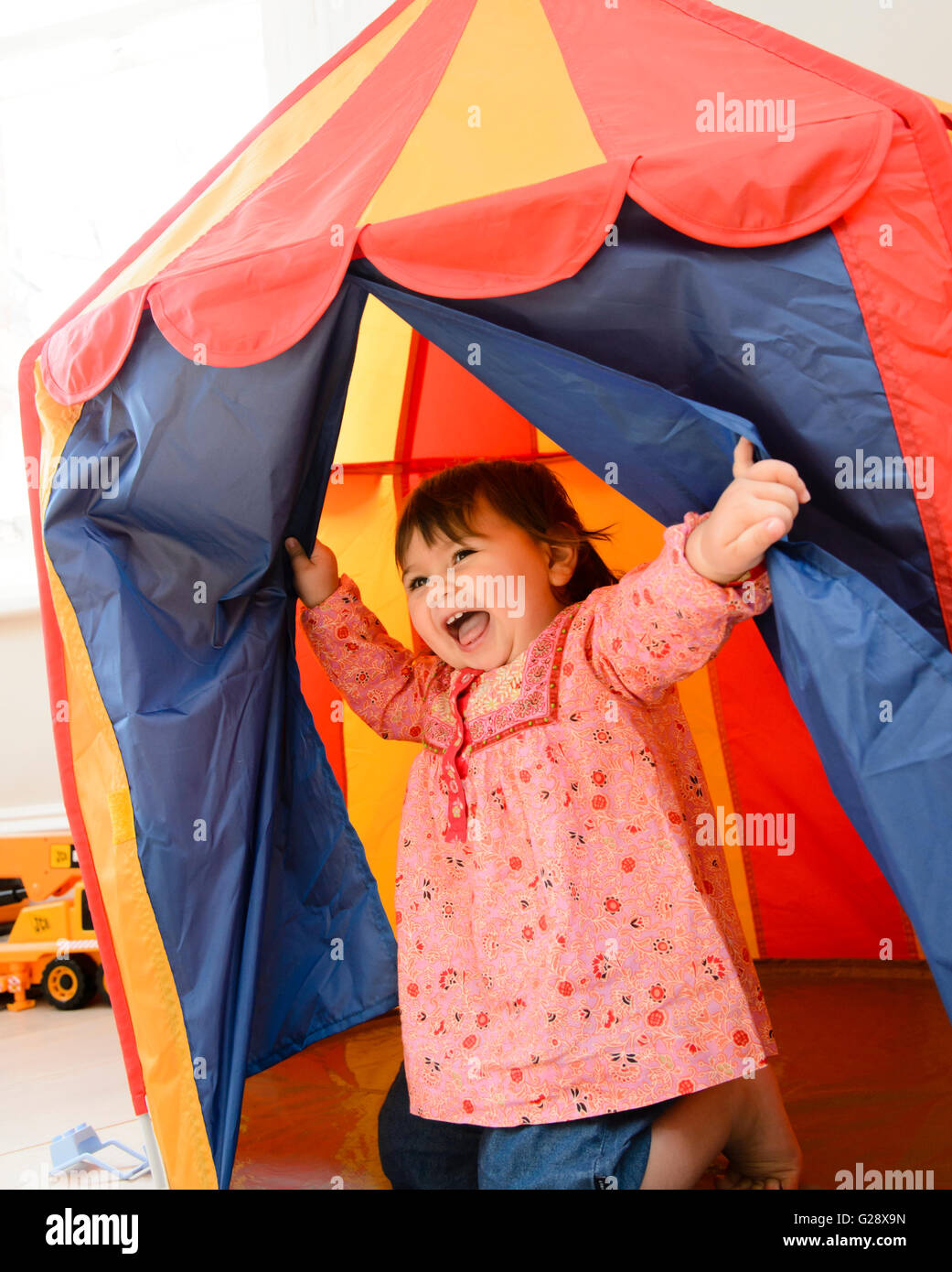 Kid playing in a children tent Stock Photo - Alamy