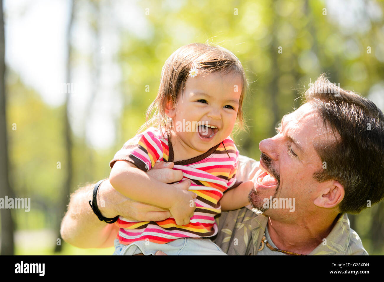 Kid and dad playing in a city park Stock Photo - Alamy