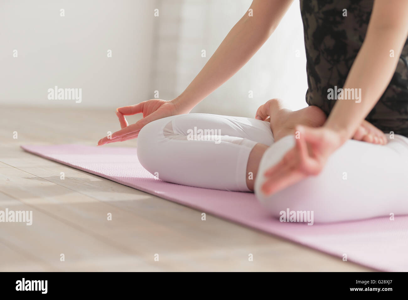 Attractive young Japanese practicing yoga in an airy room Stock Photo ...
