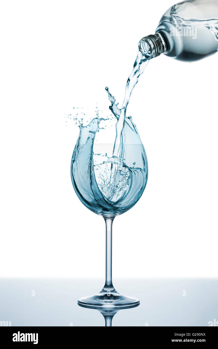 pouring natural water on glass with splashing Stock Photo - Alamy