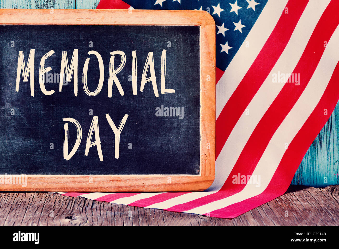 the text memorial day written in a chalkboard and a flag of the United ...