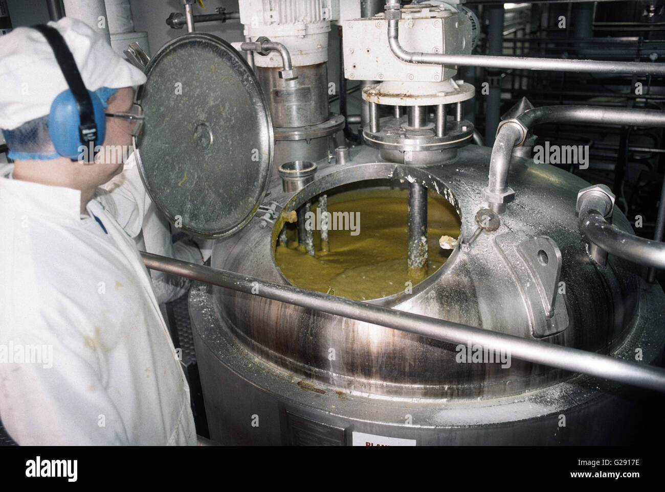 food factory worker inspecting food in a huge vat Stock Photo - Alamy