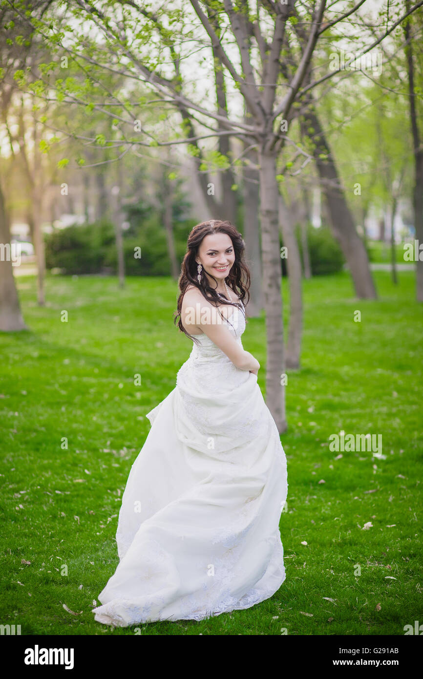 Beautiful bride posing outdoors alone Stock Photo - Alamy