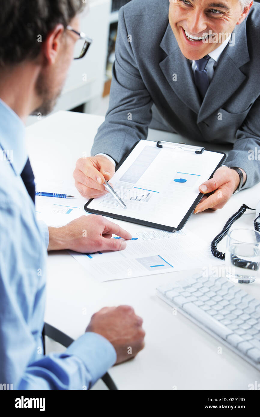 Business colleagues discussing together in an office Stock Photo - Alamy