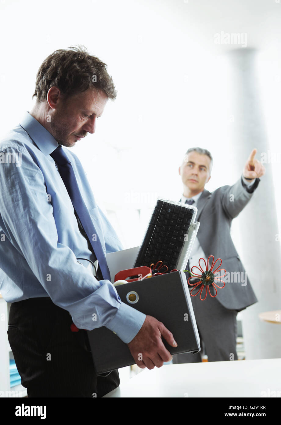 Boss dismissing an employee. Dejected fired office worker carrying a ...