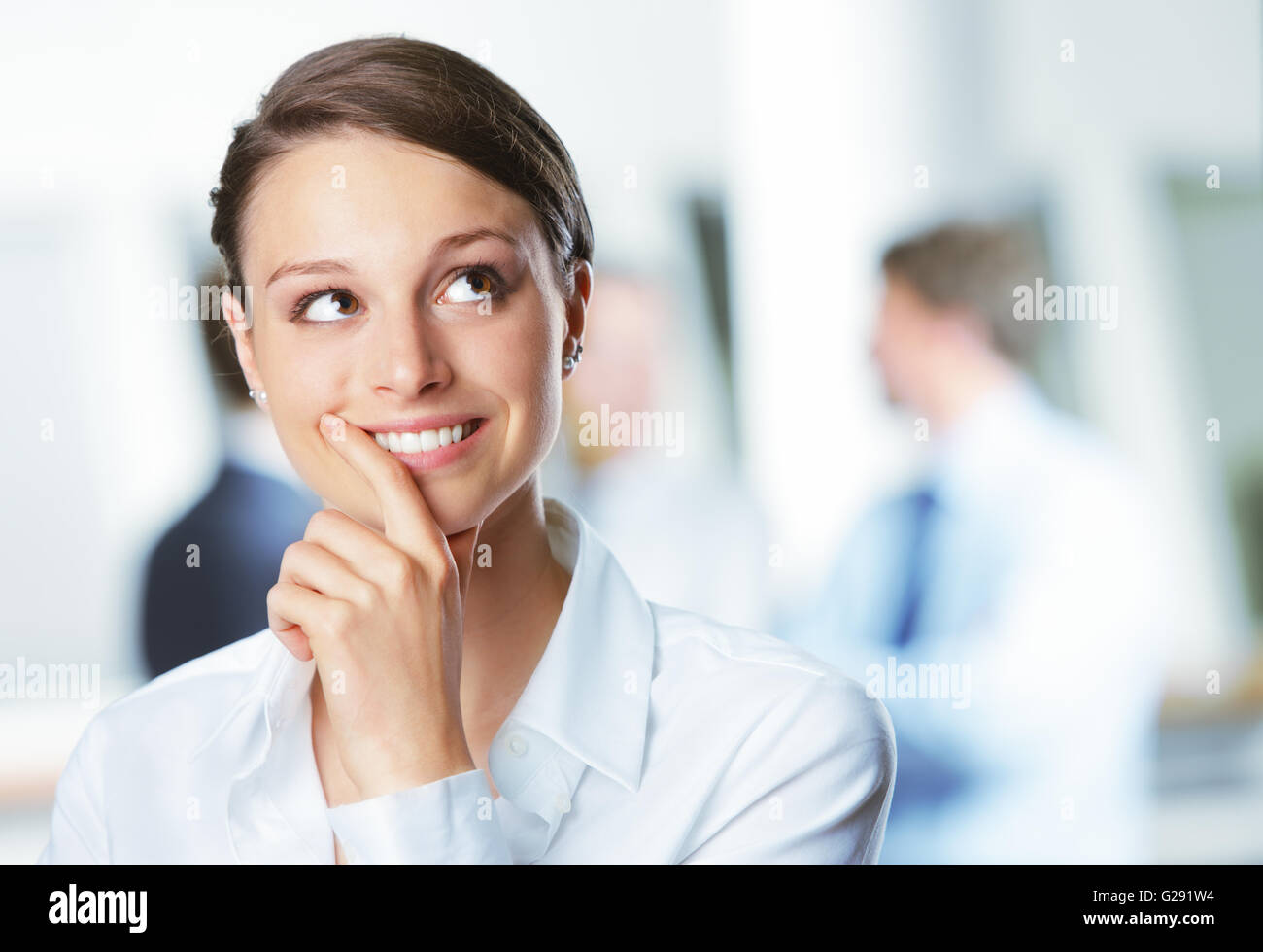 Beautiful young businesswoman thinking, looking up Stock Photo - Alamy