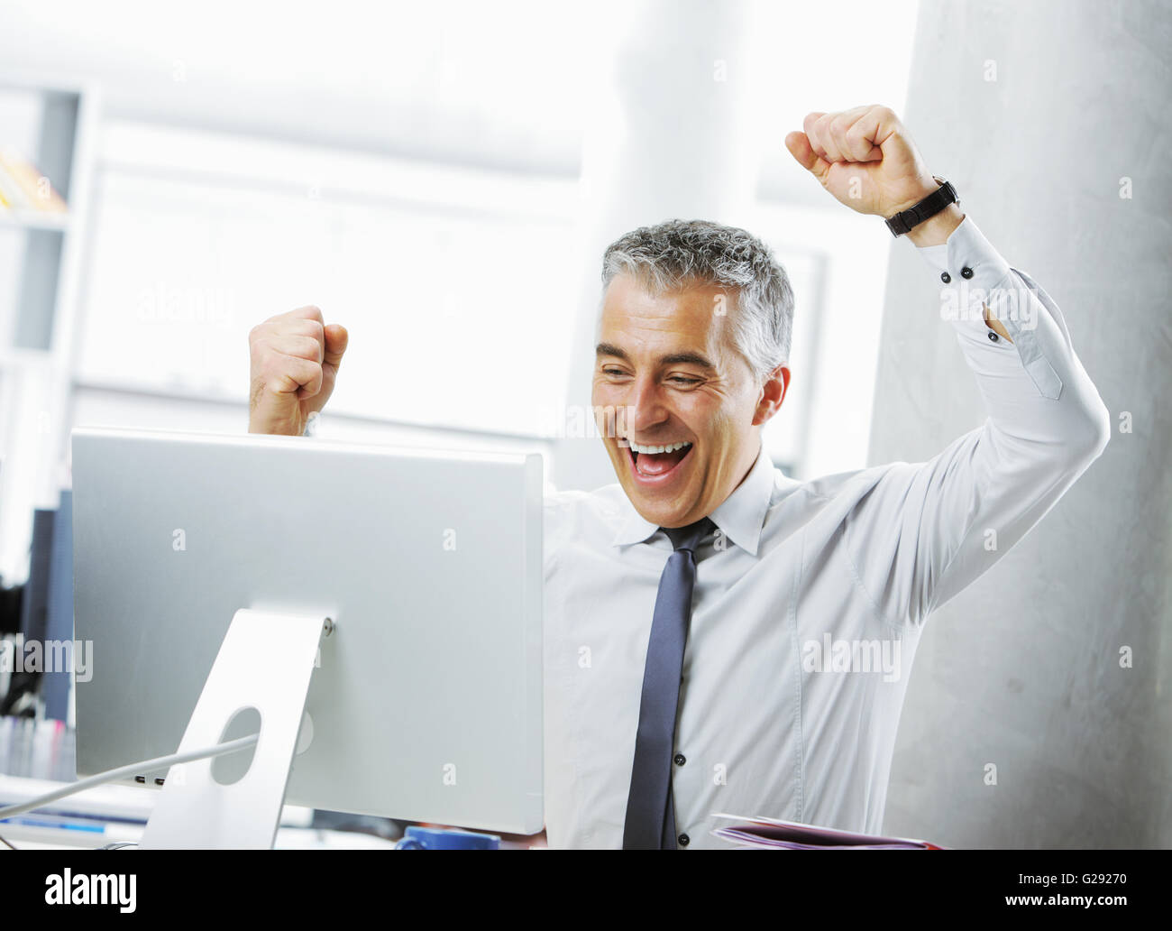 Arms raised celebrating smiling hi-res stock photography and images - Alamy