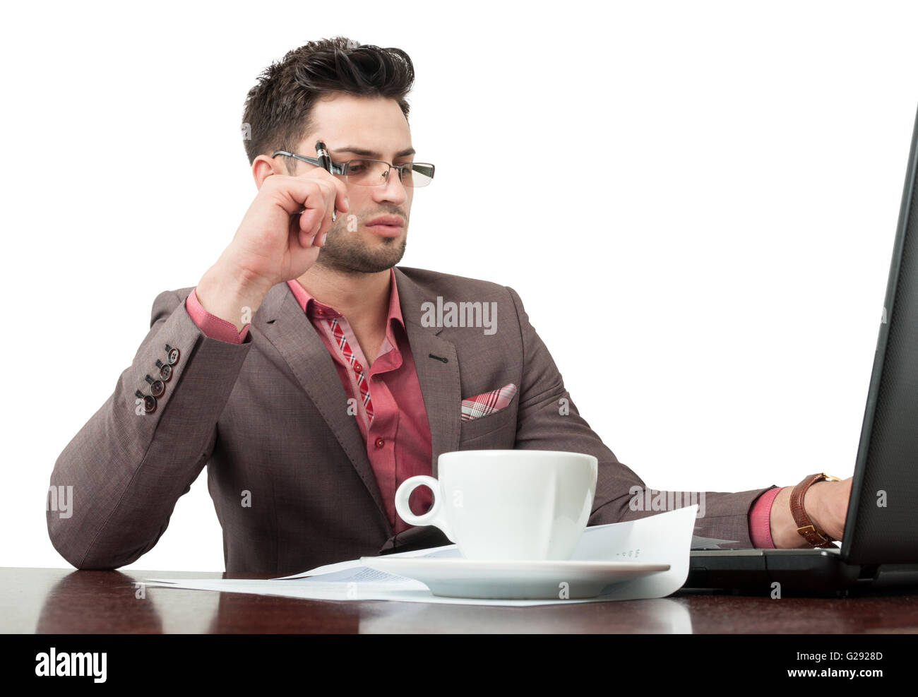 Intelligent business man working on his laptop and thinking Stock Photo ...