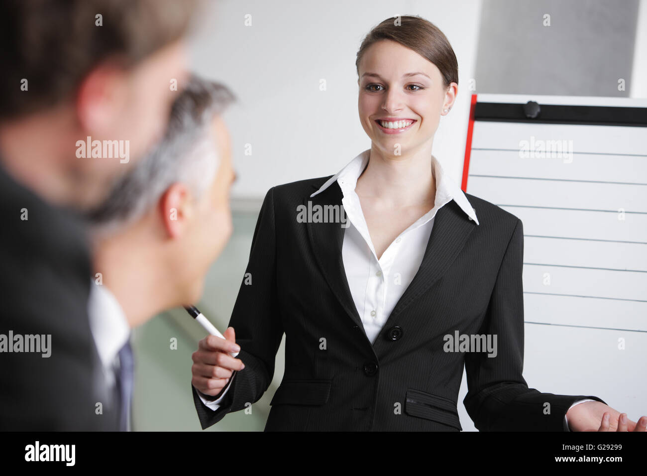 Confident business woman giving a presentation on whiteboard Stock ...