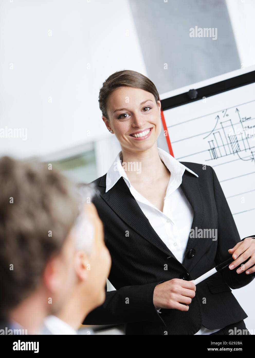 Portrait of a smiling businesswoman giving a presentation at work Stock ...