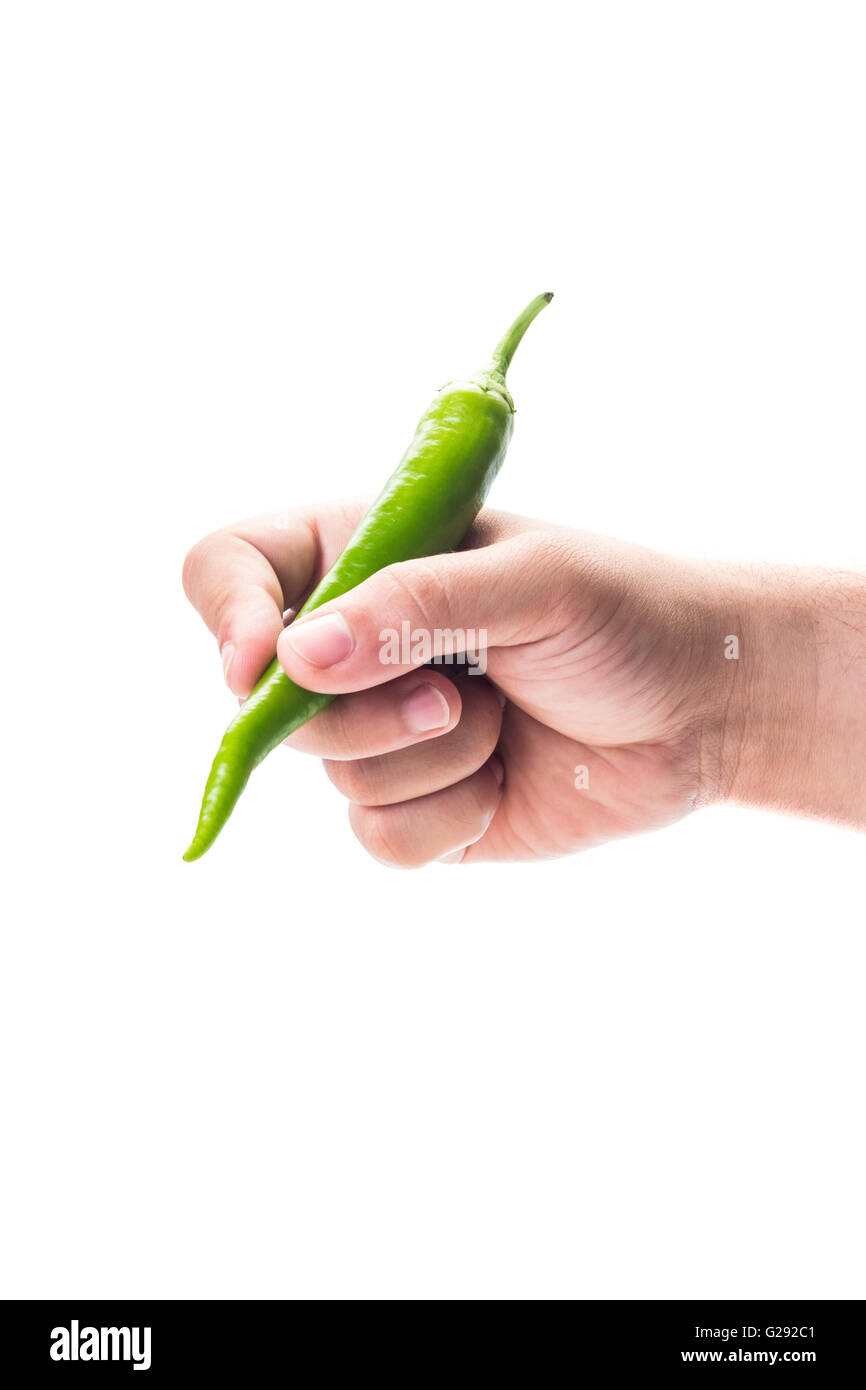 White male hand holding a green pepper like a pen ready to write and ...