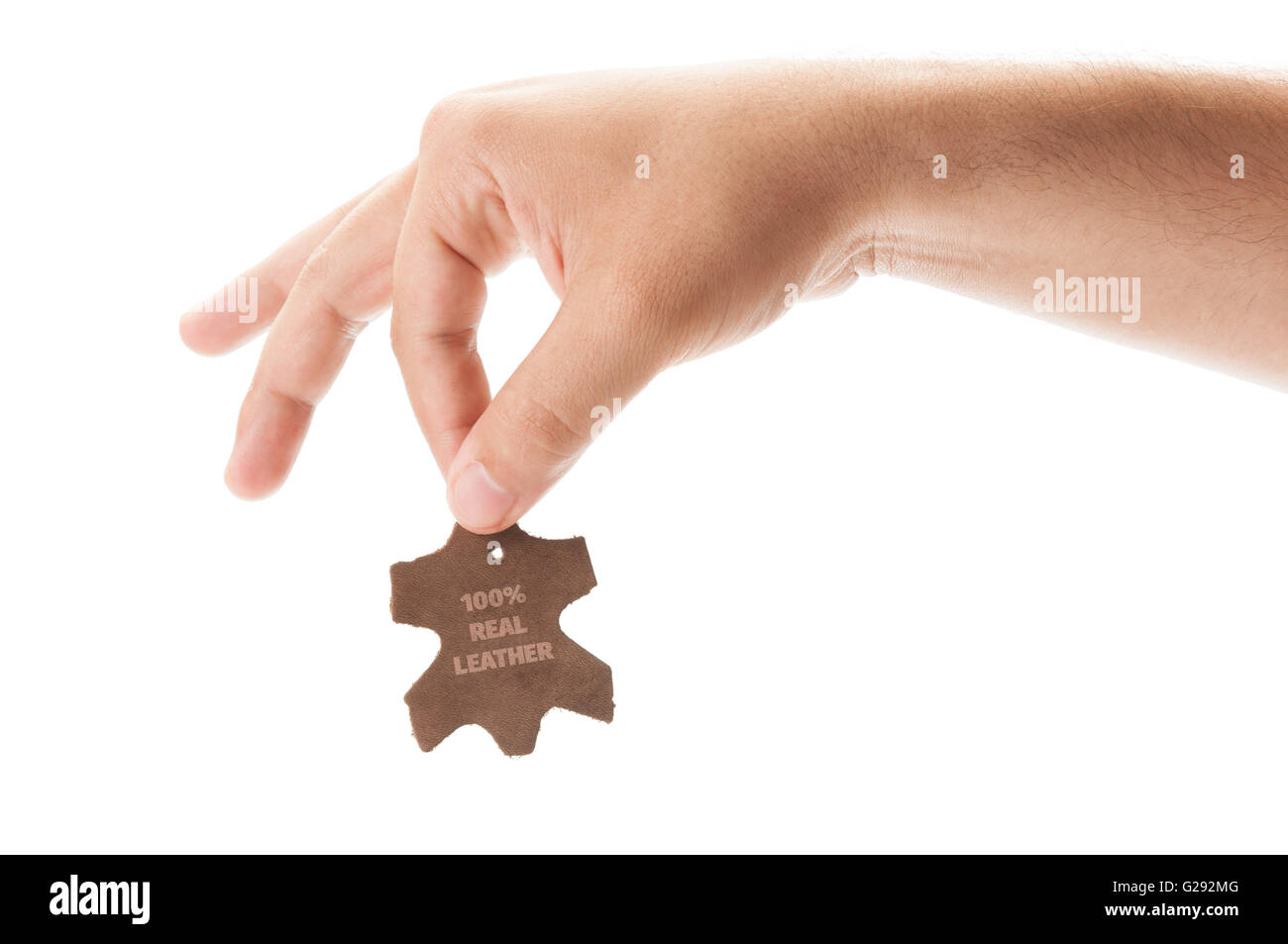 White hand holding a real leather sign on white background Stock Photo ...