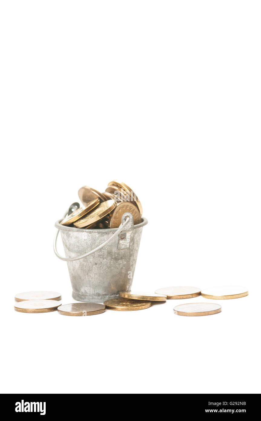 Bunch of golden coins in a small bucket isolated on white background ...