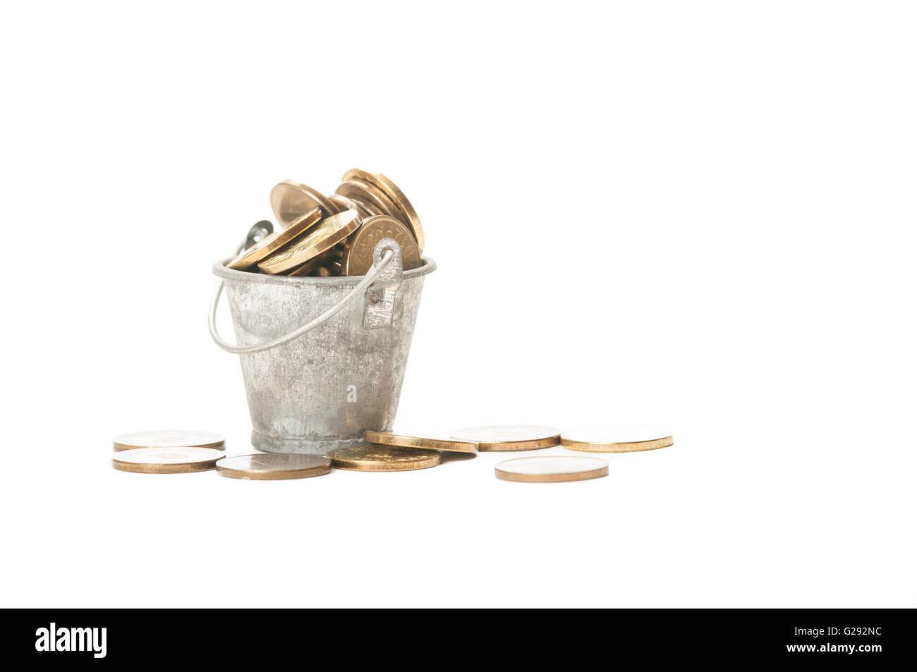 Bunch of romanian golden coins in a small bucket isolated on white ...