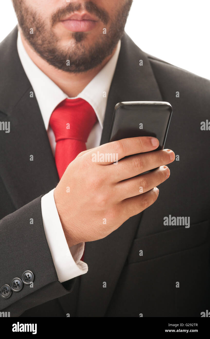 Business man checking his smartphone while wearing a classic black suit ...