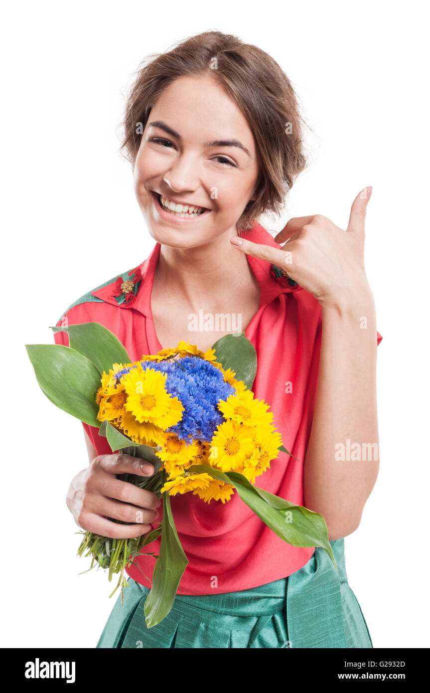 Woman making call me gesture with hand while holding flowers on white ...