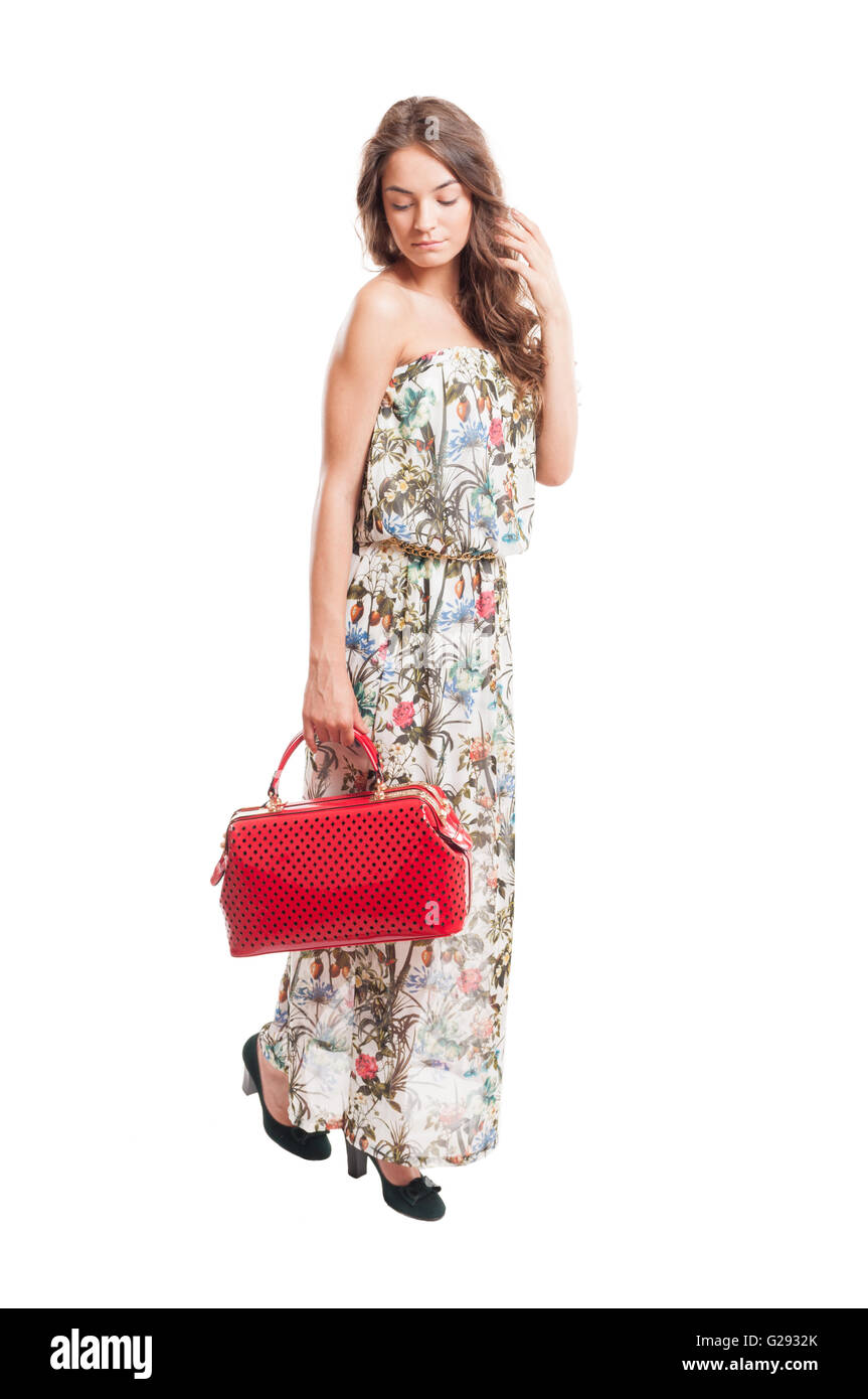 Beautiful long hair female model holding a red purse isolated on white ...