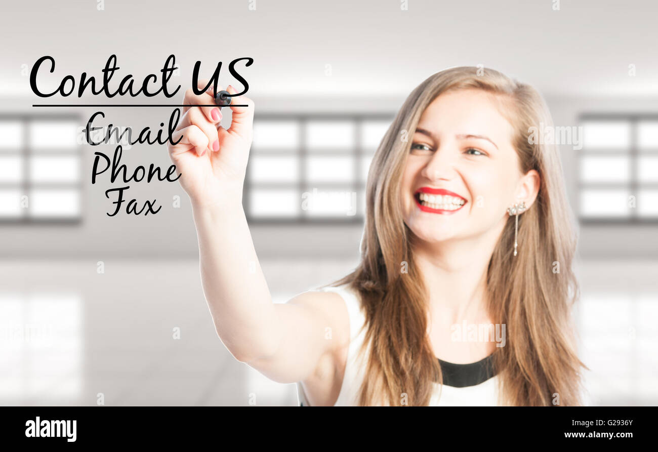 Contact us using email, phone or fax. woman writing contact us on ...