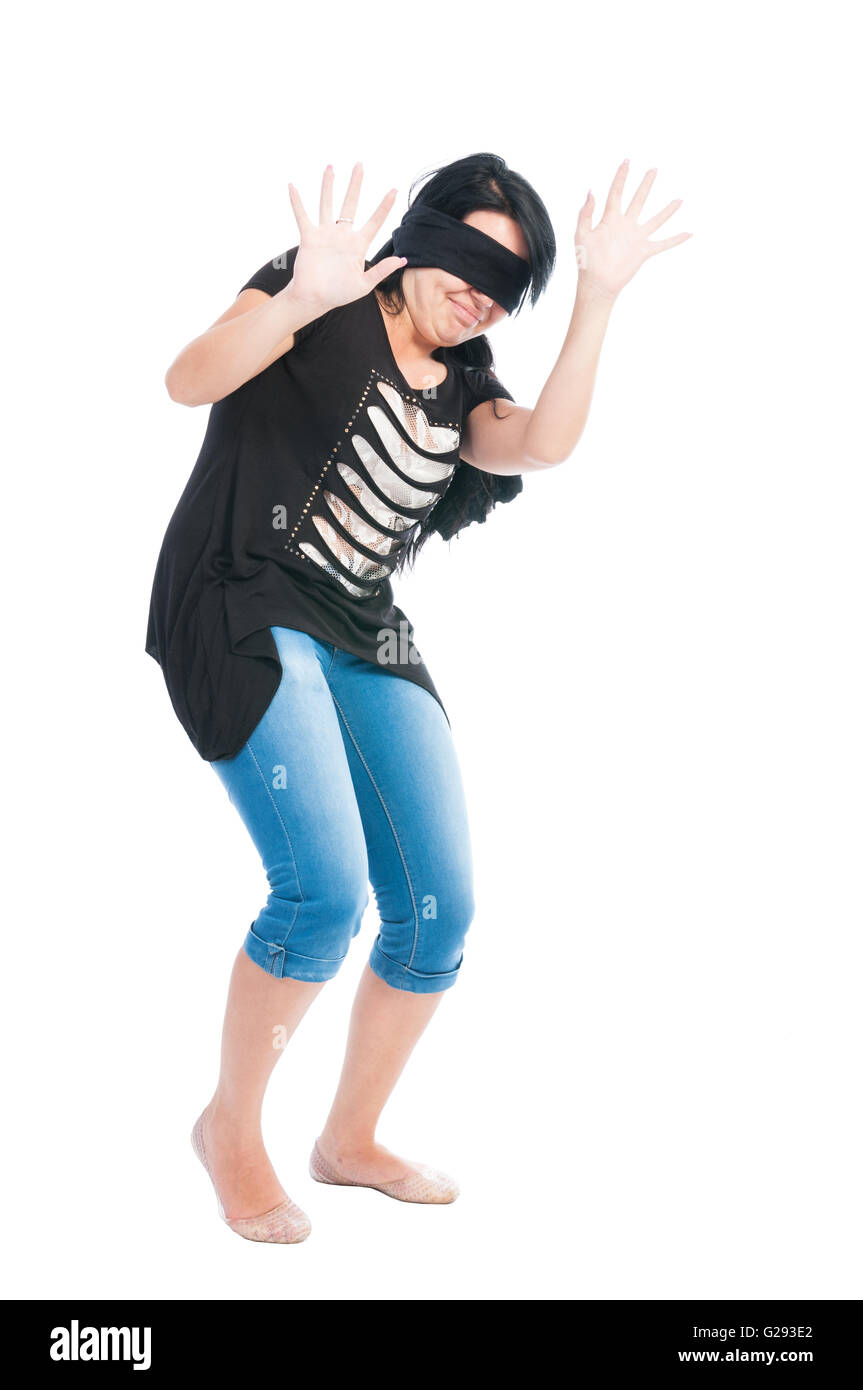 Blindfolded teen girl acting scared and raising hands to defend and ...