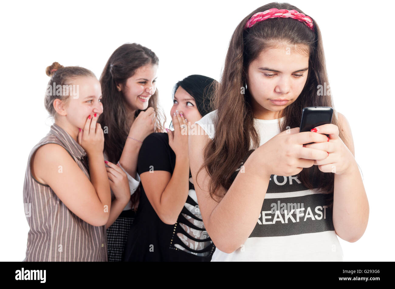 Mean and bullying teen girls on white background Stock Photo - Alamy