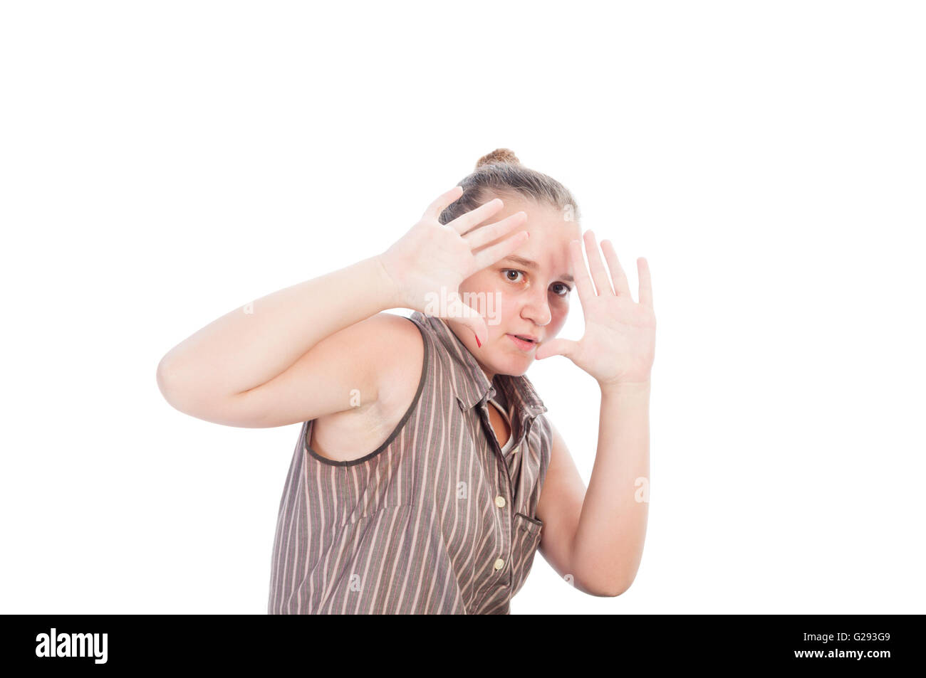 Normal teen girl acting scared on white studio background Stock Photo ...