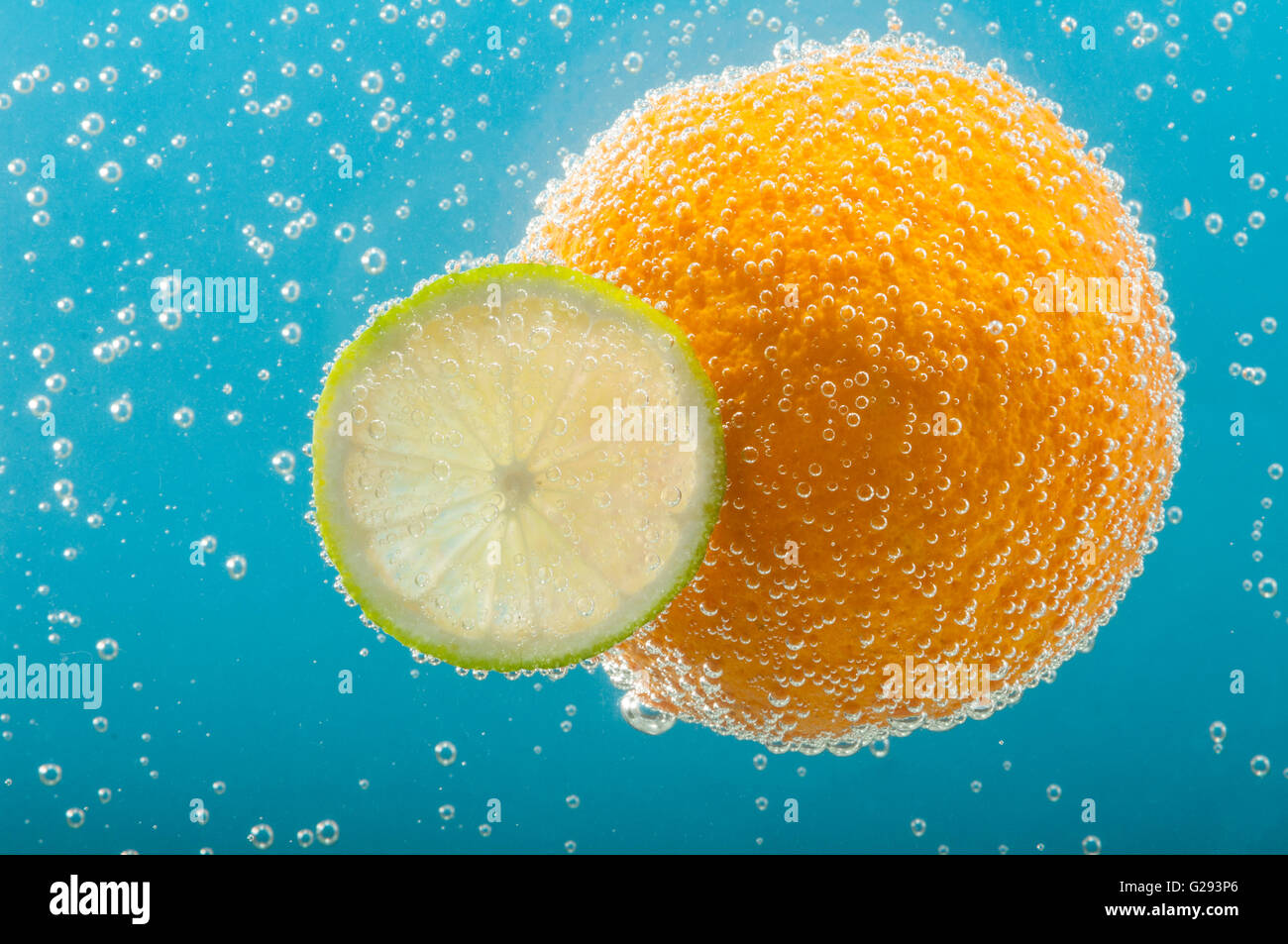 Orange and lime slice submerged in bubbles water Stock Photo - Alamy