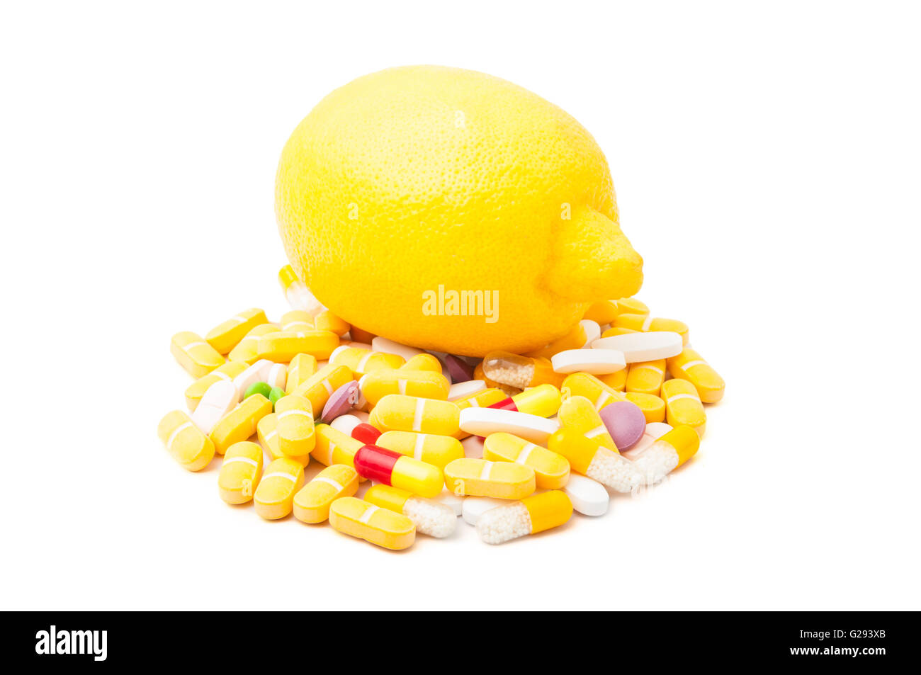 Perfect yellow lemon on bunch of colored pills isolated on white ...
